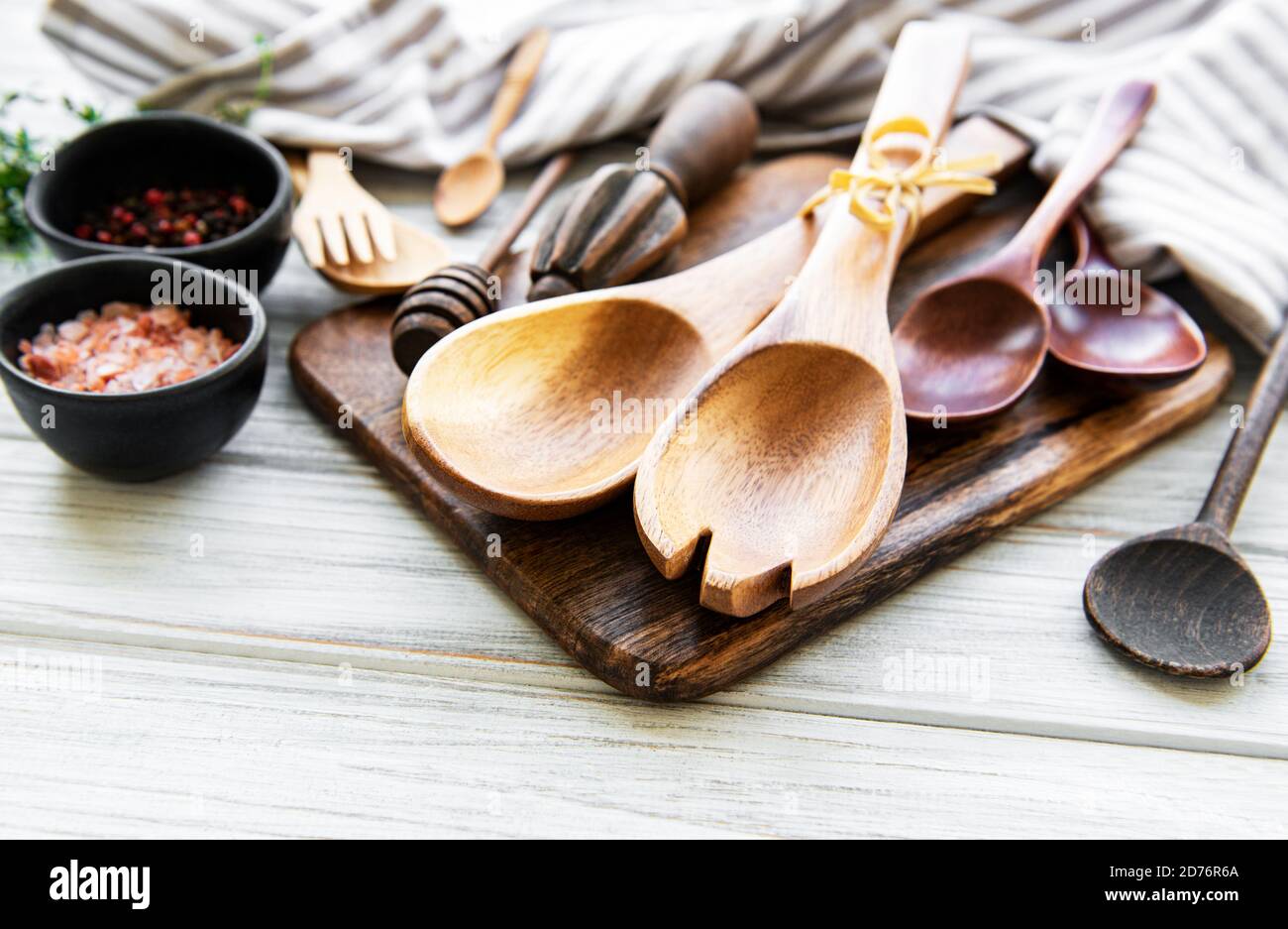Wooden cutlery kitchen ware on a white wooden background Stock Photo ...