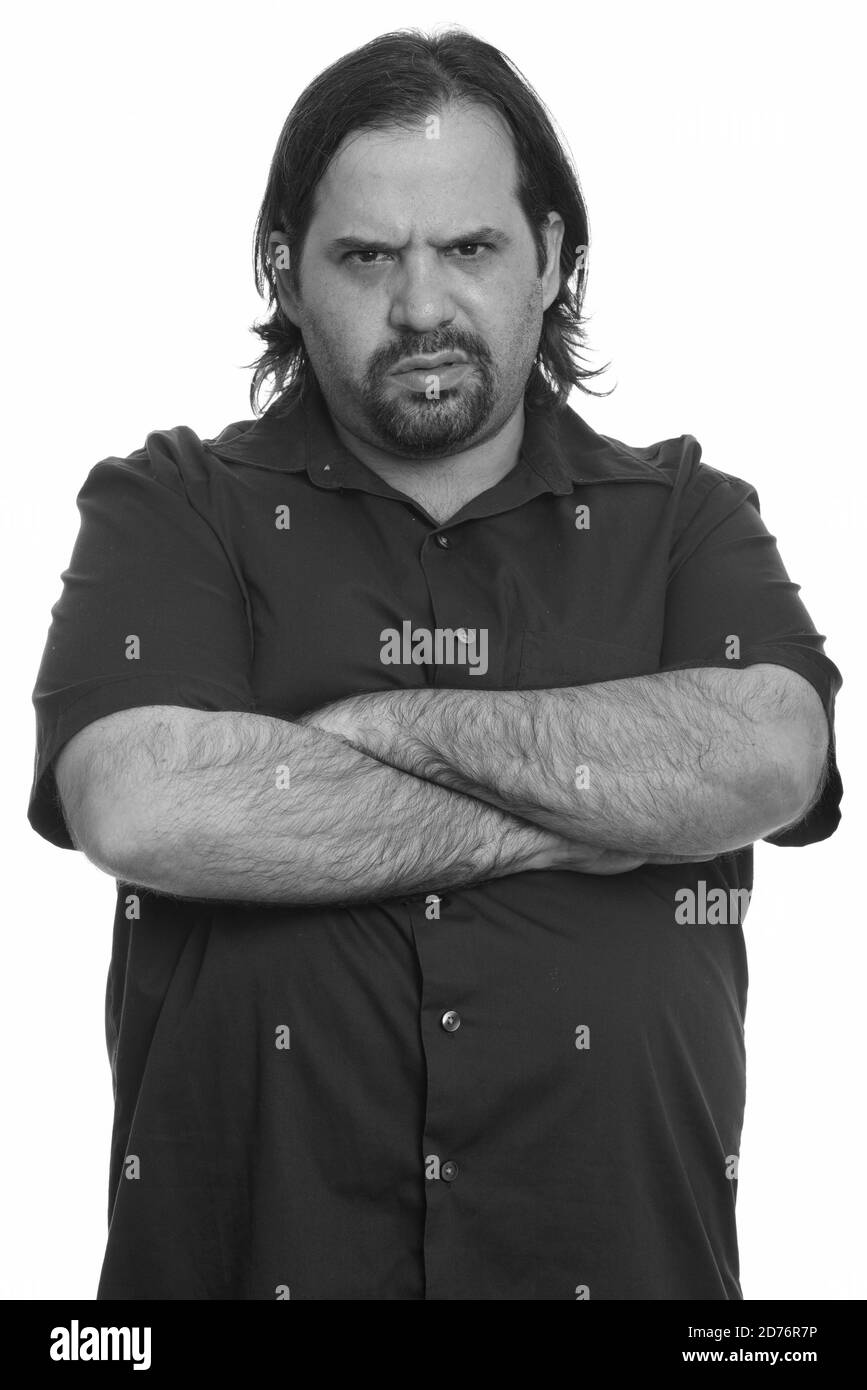 Portrait of stressed overweight bearded man looking angry with arms ...