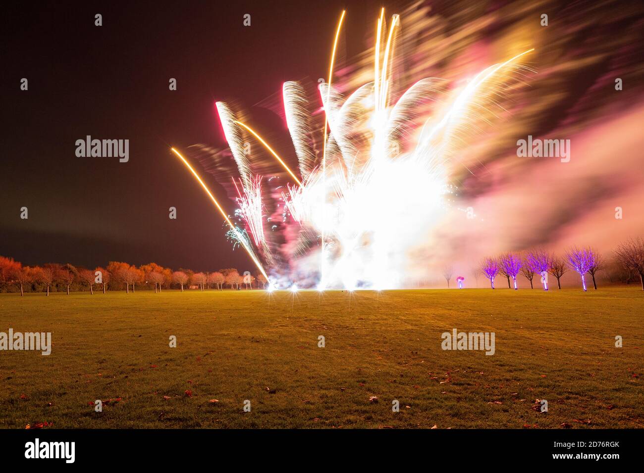 Spectacular and colourful firework display set against a dark Autumn ...