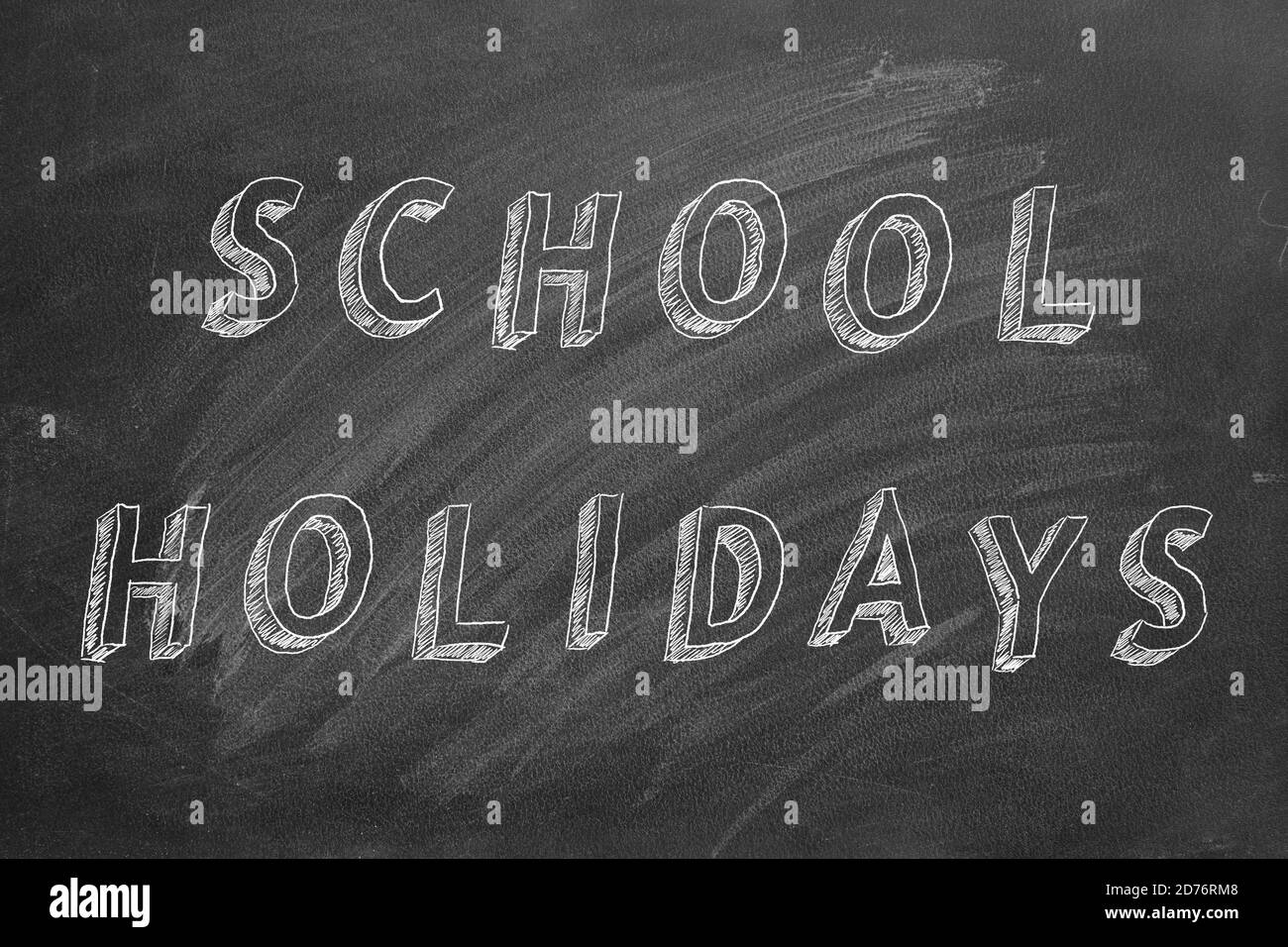 Hand drawing text "School holidays" on blackboard Stock Photo - Alamy
