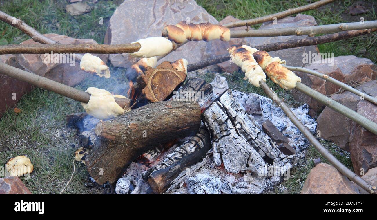Making stick bread around the campfire Stock Photo - Alamy