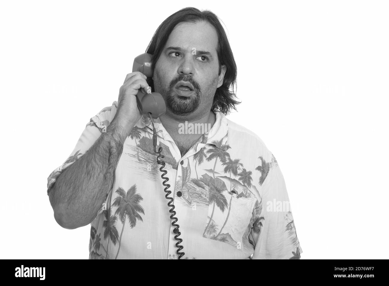 Fat Caucasian man talking on old telephone looking tired Stock Photo ...