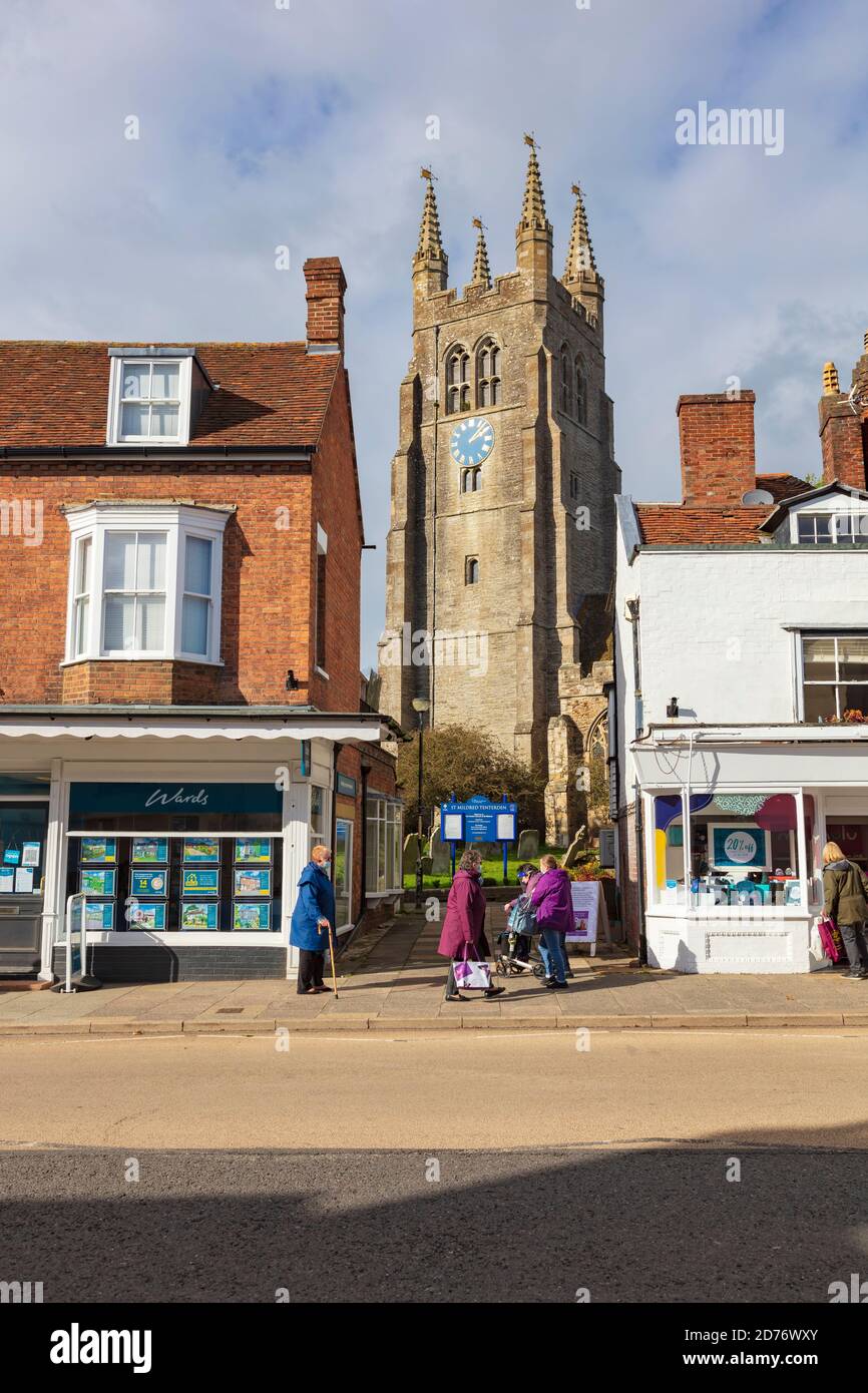 Shops and St Mildred's church tower on the attractive High Street in ...