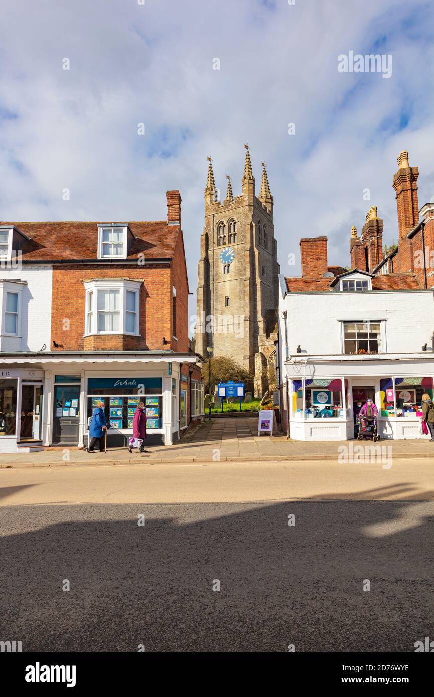Shops and St Mildred's church tower on the attractive High Street in ...