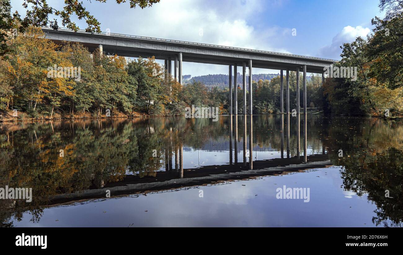 Beam bridge over a river running through an autumn forest Stock Photo ...