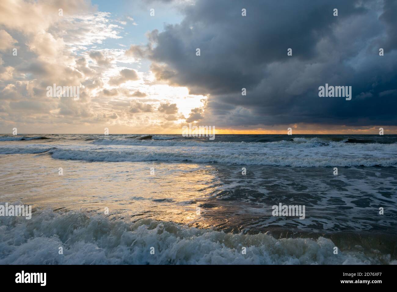 Reflection of the setting sun on the north sea hi-res stock photography ...