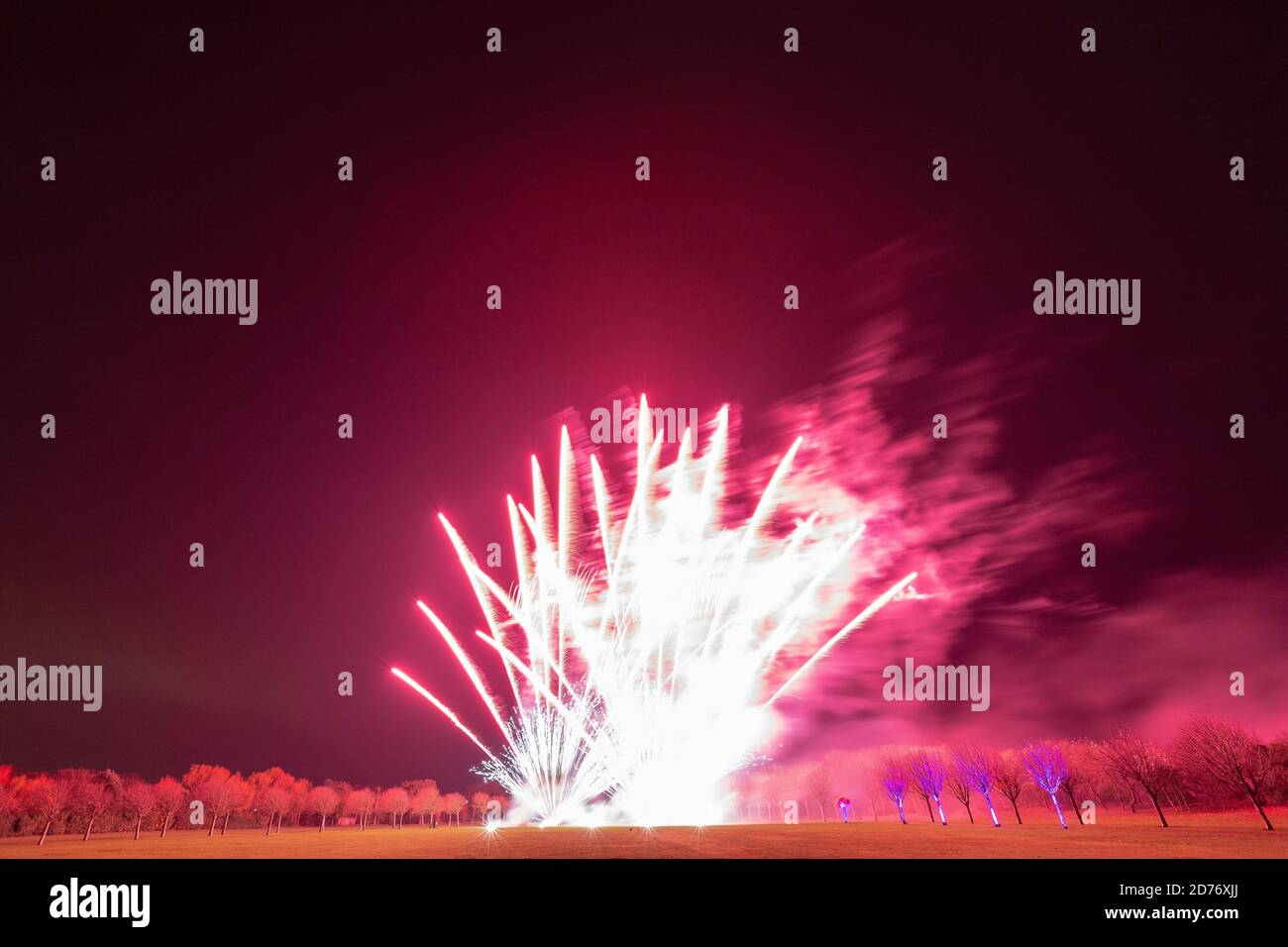 Spectacular and colourful firework display set against a dark Autumn ...
