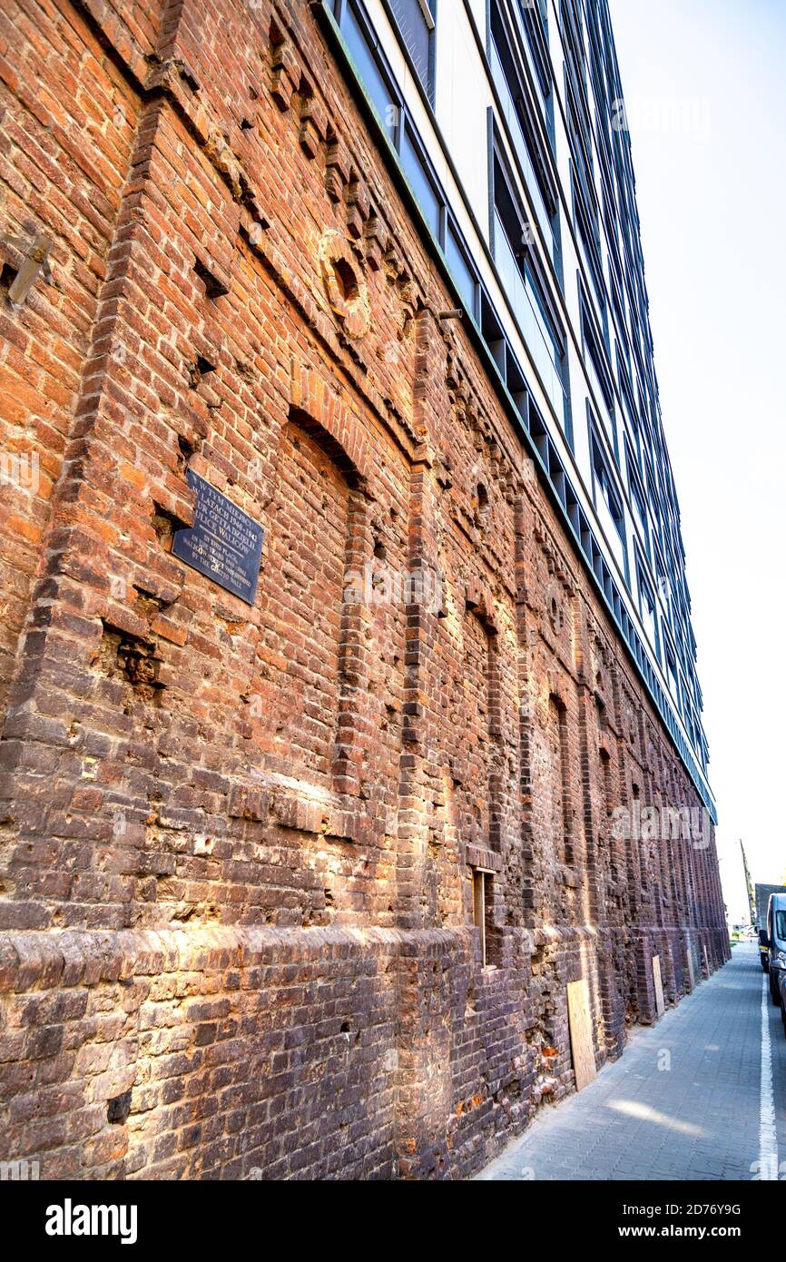 Remains of World War II ghetto wall incorporated into a modern building ...