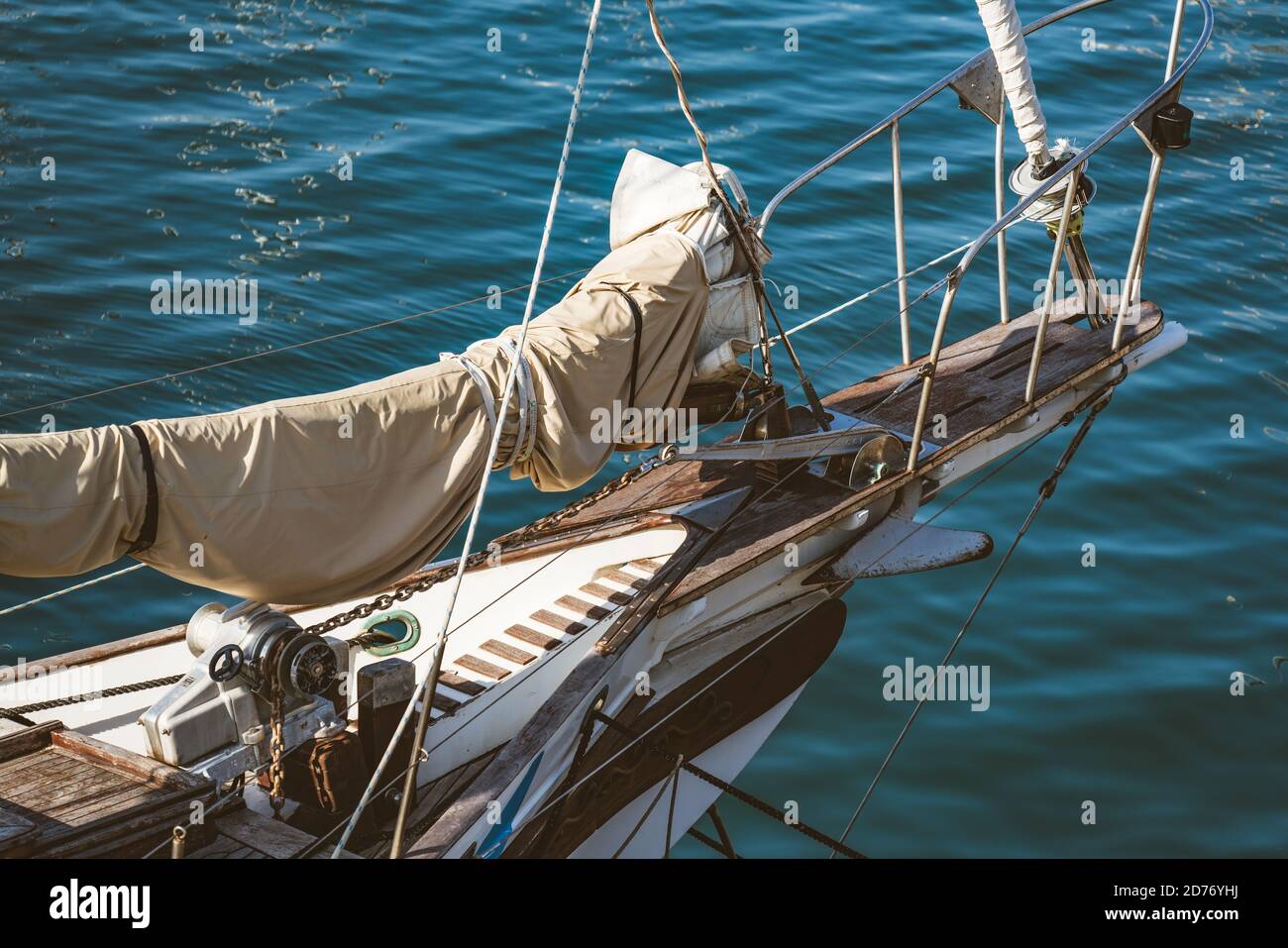 Sail folded over the prow deck of an old wooden sailboat Stock Photo - Alamy