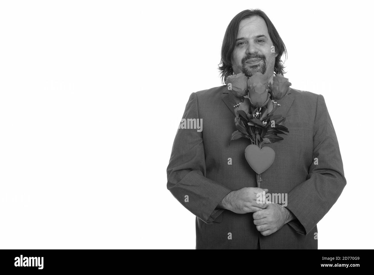 Happy fat Caucasian businessman smiling holding red roses and heart ...