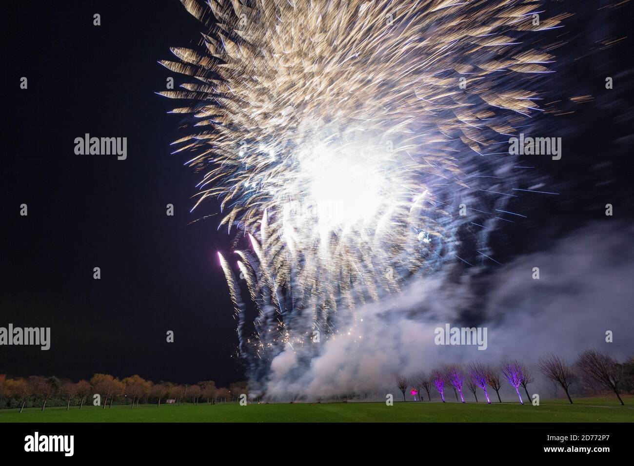 Spectacular and colourful firework display set against a dark Autumn ...