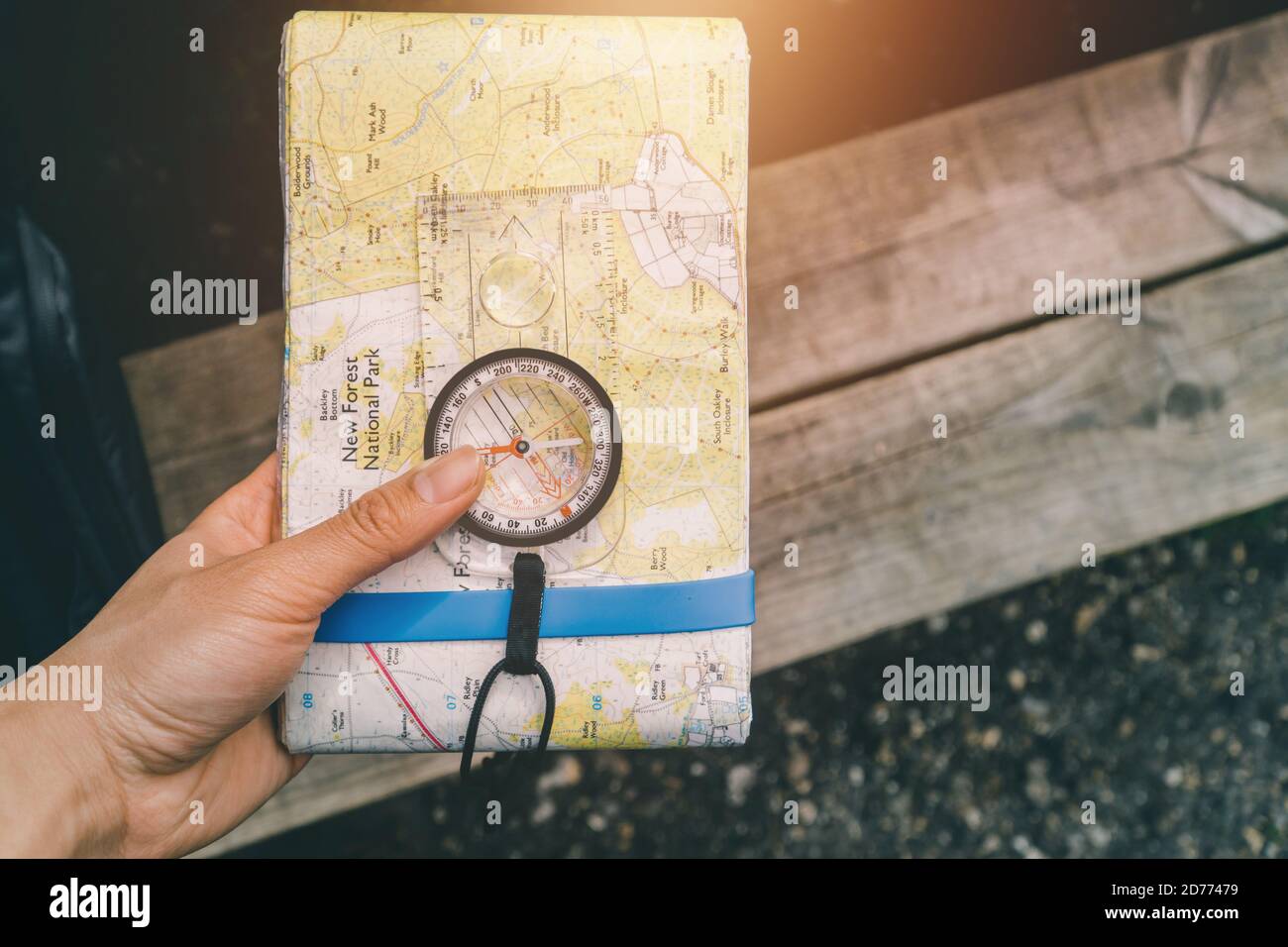Reading map and compass in the forest Stock Photo - Alamy