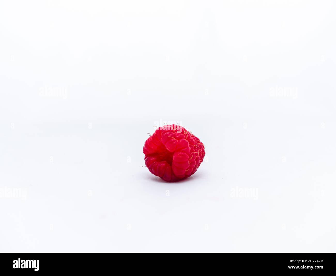 Ripe red juicy raspberry on white background Stock Photo - Alamy