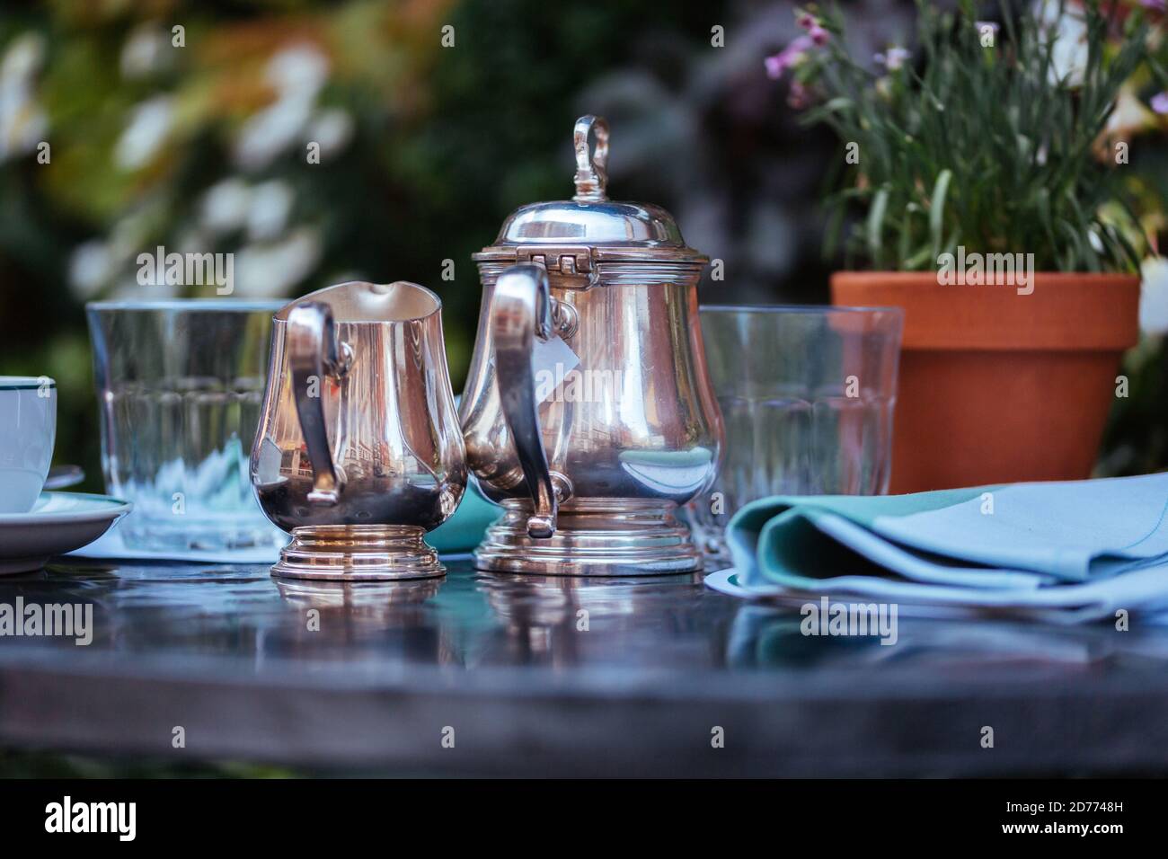 Outdoor luxury restaurant terrace, afternoon tea, tea pot on tables in ...