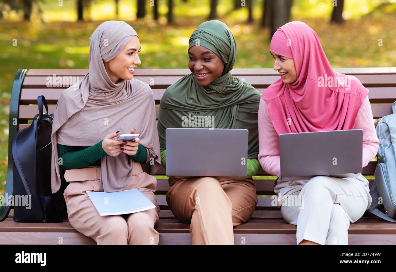 Muslim Female Students Using Laptops And Smartphone Learning Together ...