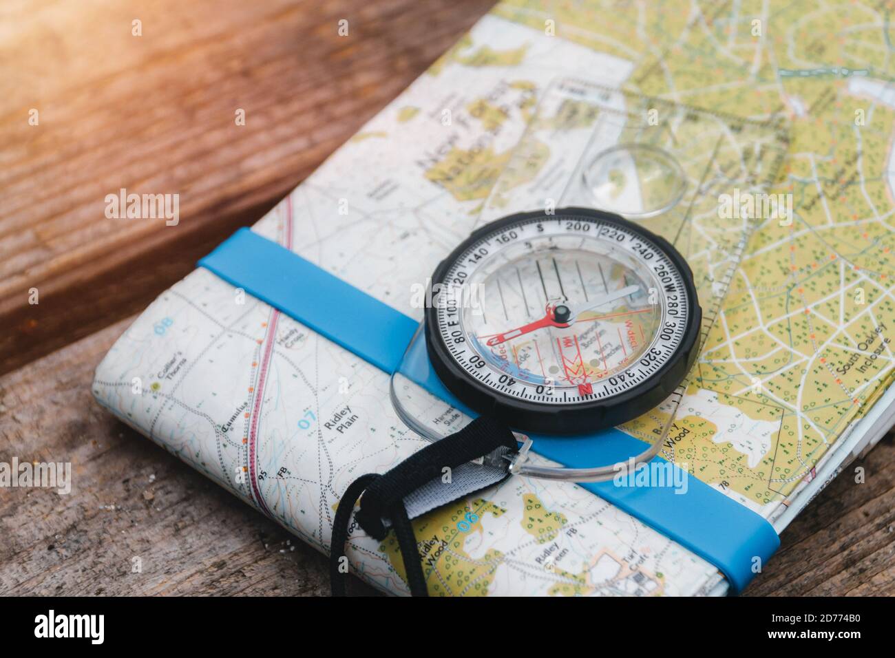 Southampton New Forest, UK July 14, 2018: Map and compass on the table ...
