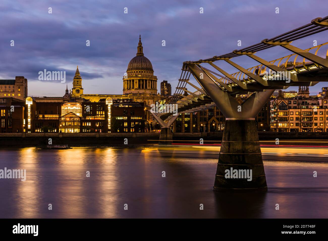 Lights and boat trails over the River Thames at the Millennium Bridge ...
