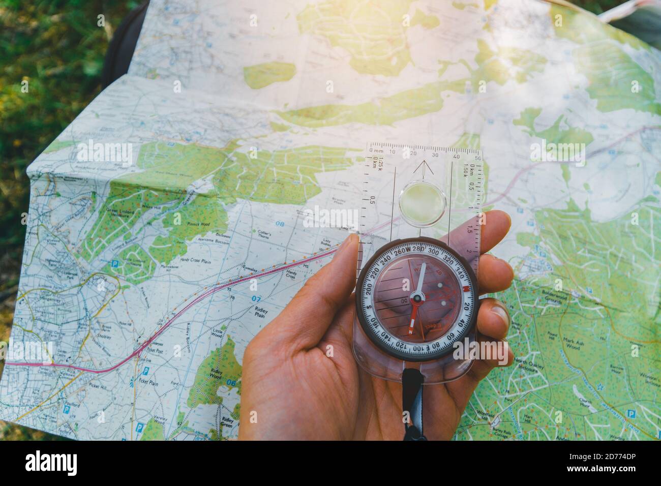 Southampton New Forest, UK July 14, 2018: Holding map and compass in ...