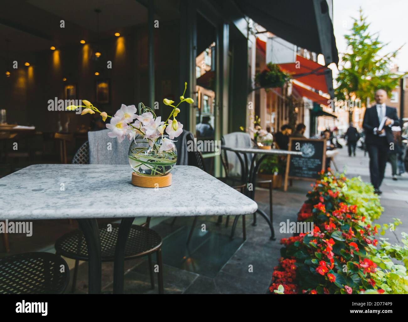 Street view with restaurant terrace during the morning in London ...