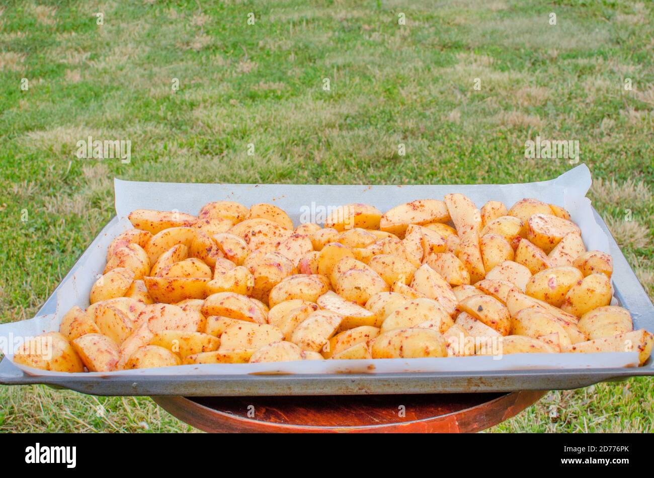 Raw chopped potatoes on a baking sheet Stock Photo - Alamy