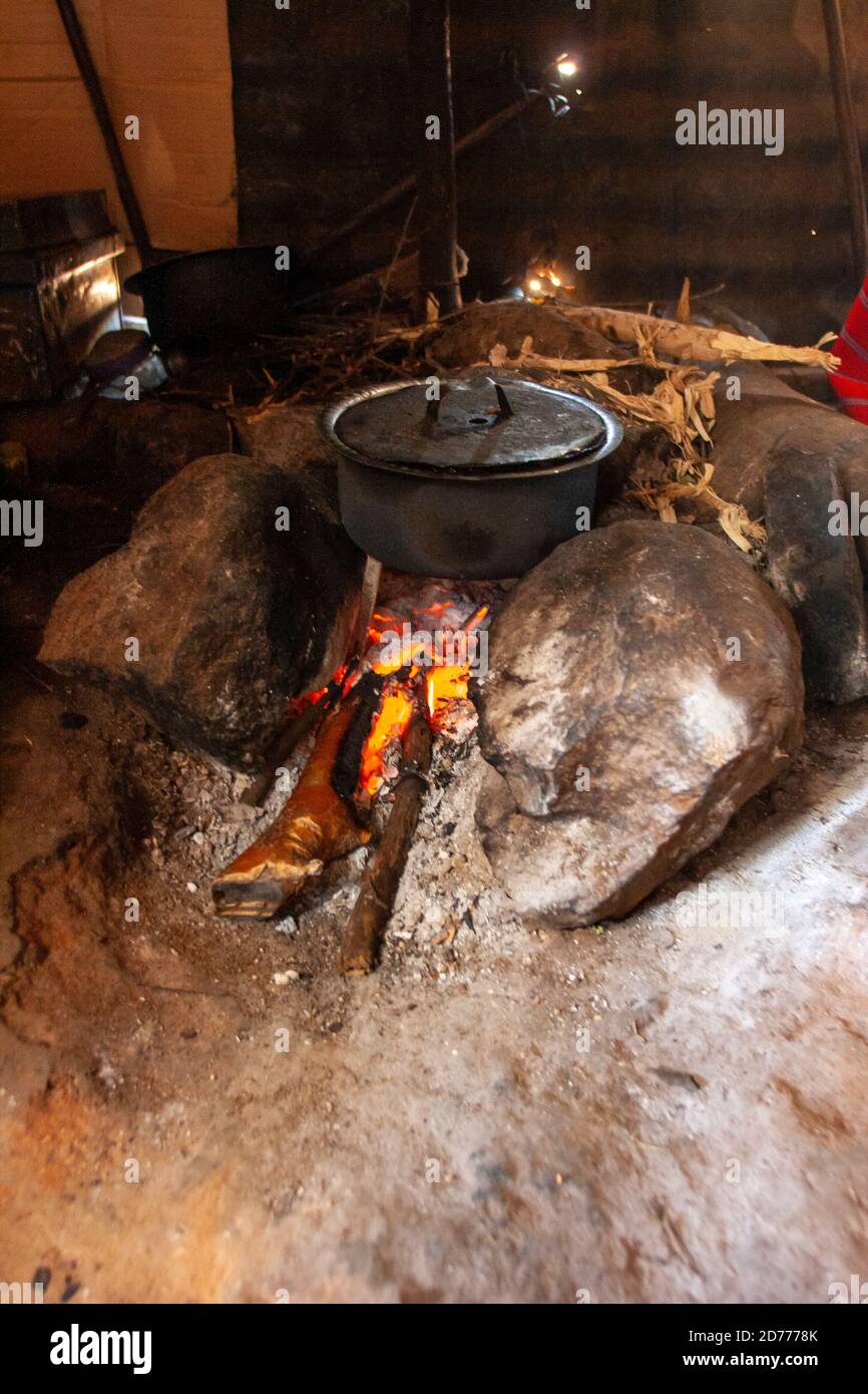 cooking on an open fire in the interior of a hut in a Samburu tribe ...
