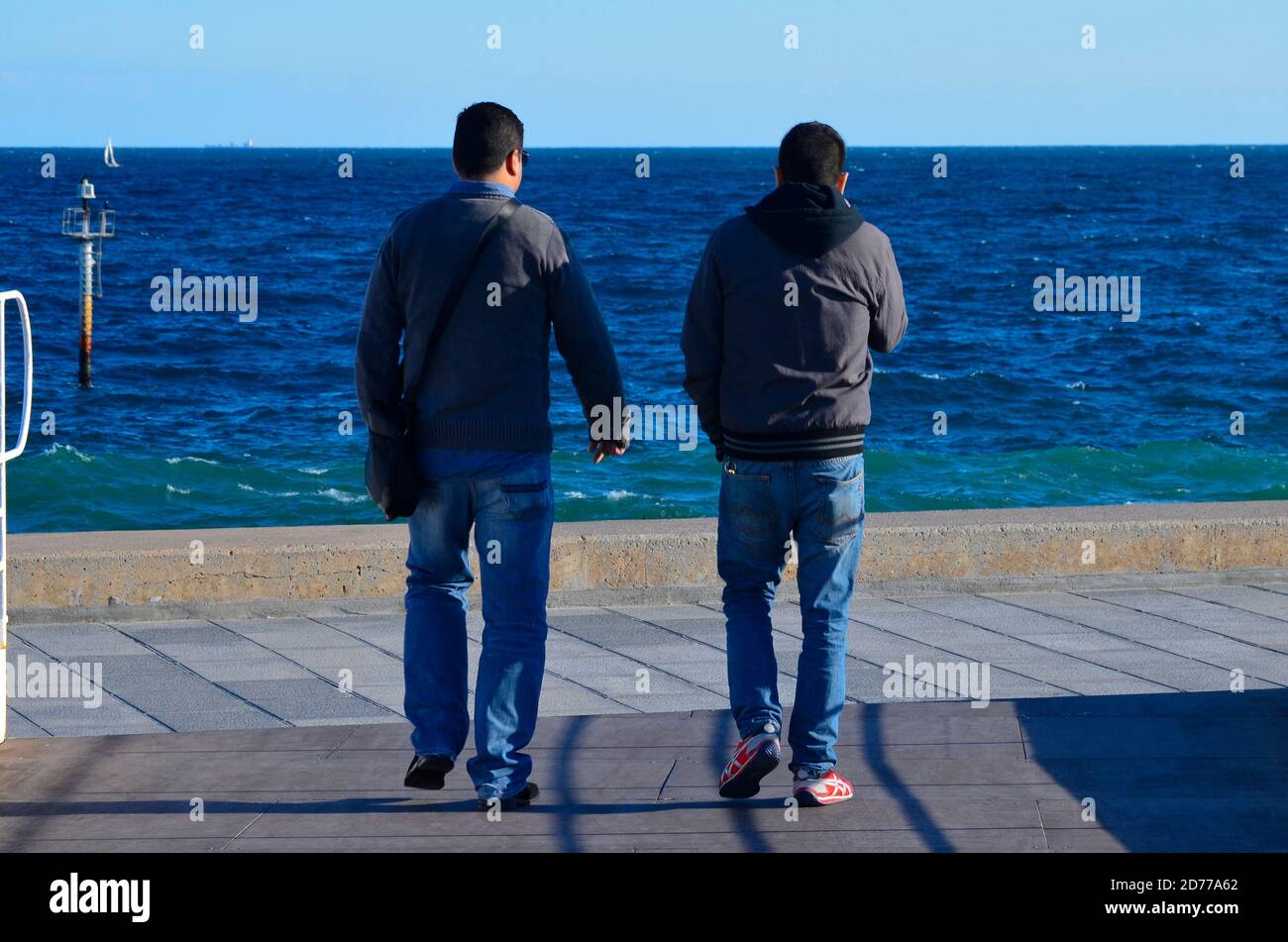 Two men beach walking winter hi-res stock photography and images - Alamy