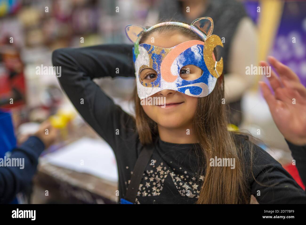 Happy young girl wearing carnival mask Stock Photo - Alamy