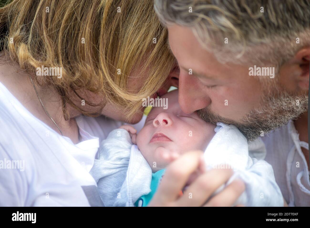 Newborn baby embraced by his parents. Family and love concept Stock ...