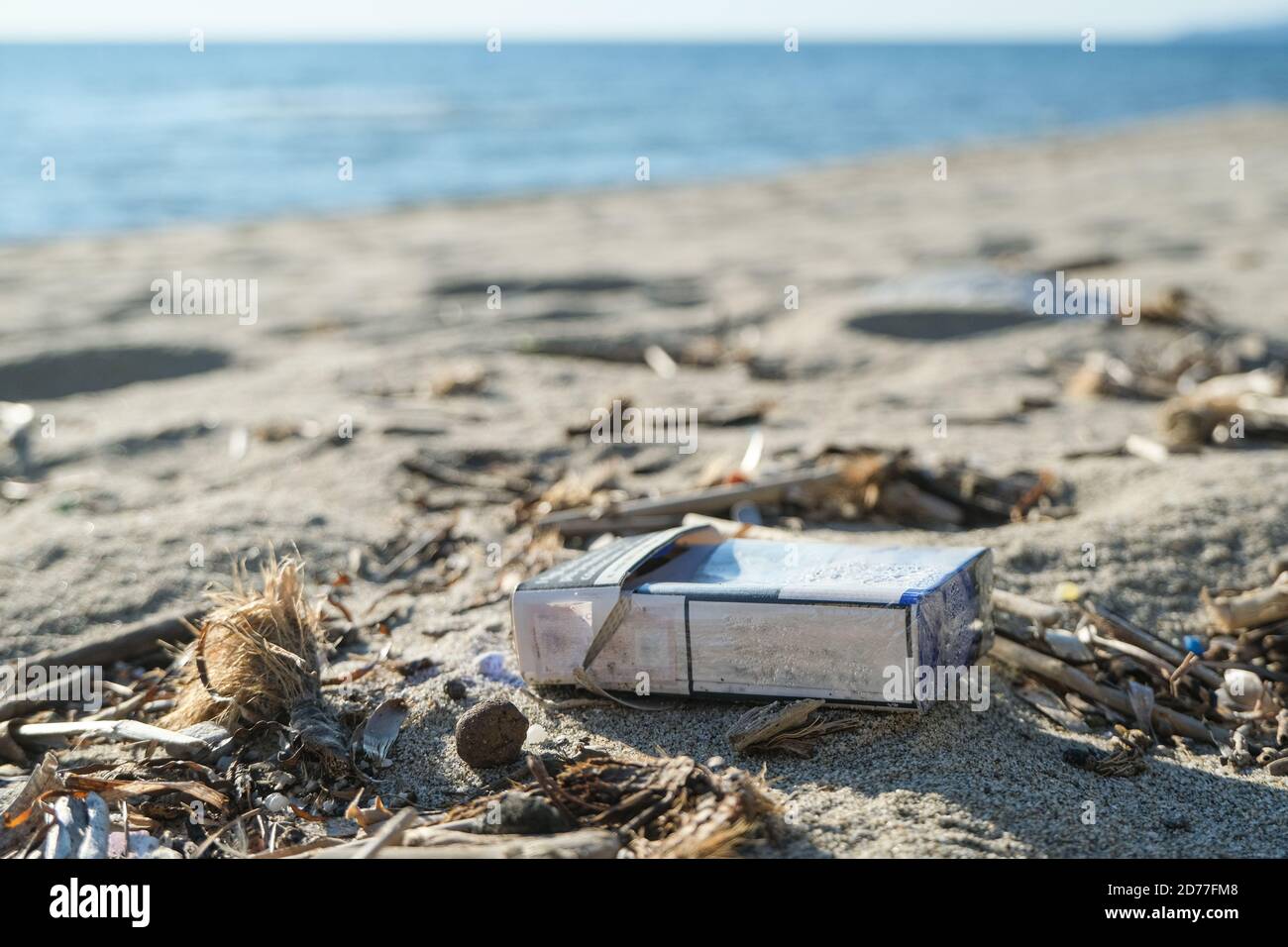 Dirty cigarette pack trash discarded on sea coast ecosystem ...