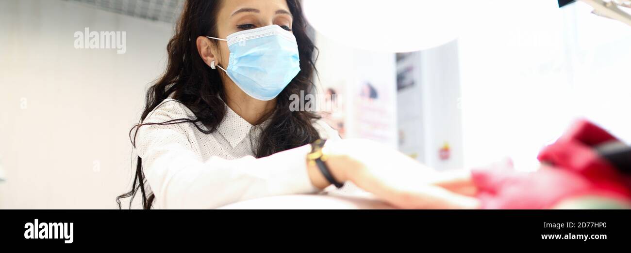 Brunette woman getting nails done Stock Photo - Alamy