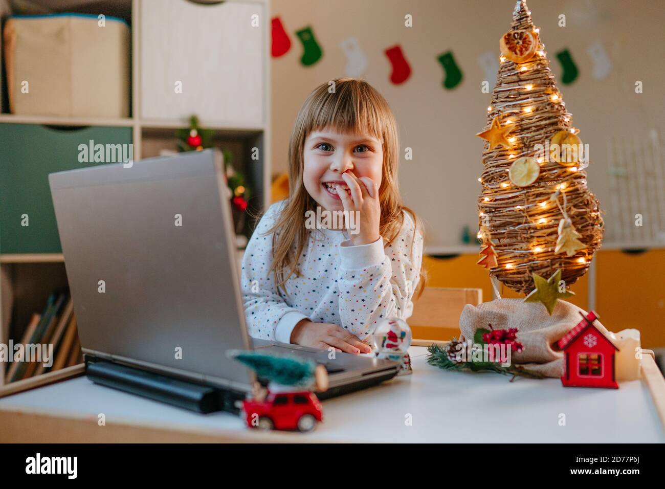 Little girl using laptop for video call Stock Photo - Alamy