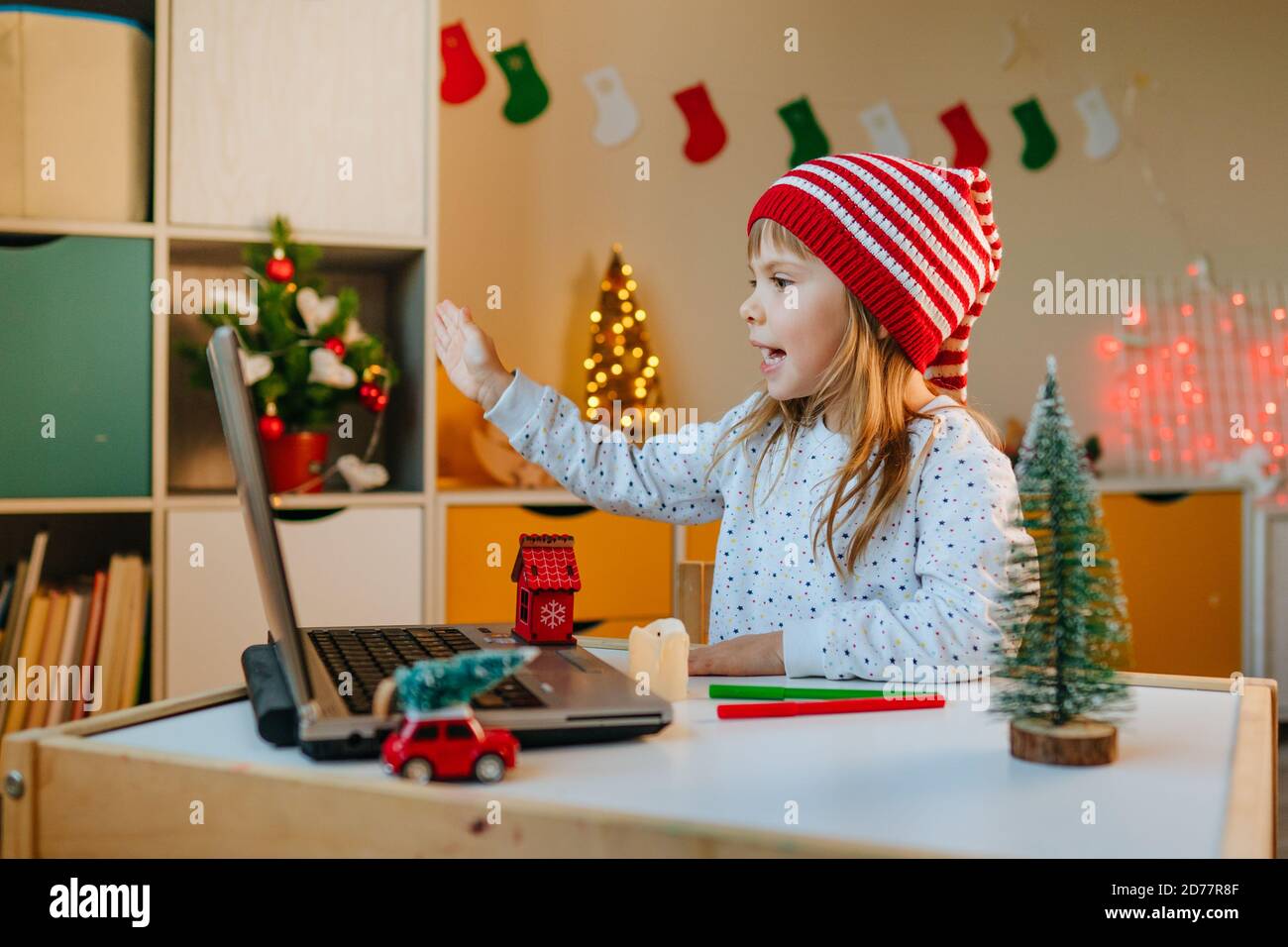 Little girl using laptop for video call Stock Photo - Alamy