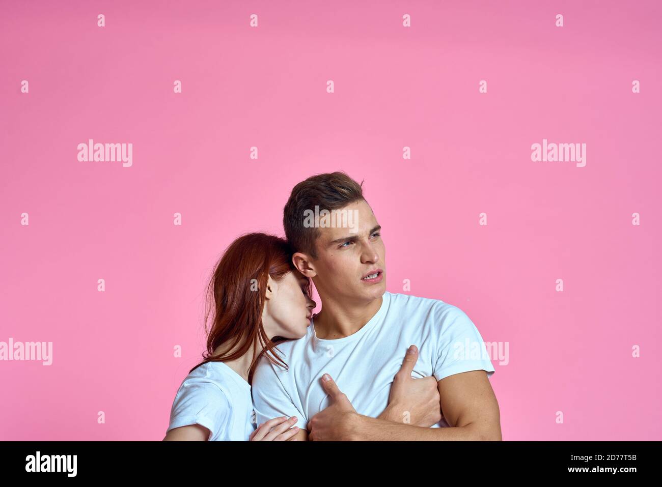 enamored man and woman hugging each other on a pink background cropped ...