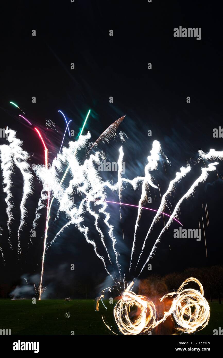 Spectacular and colourful firework display set against a dark Autumn ...
