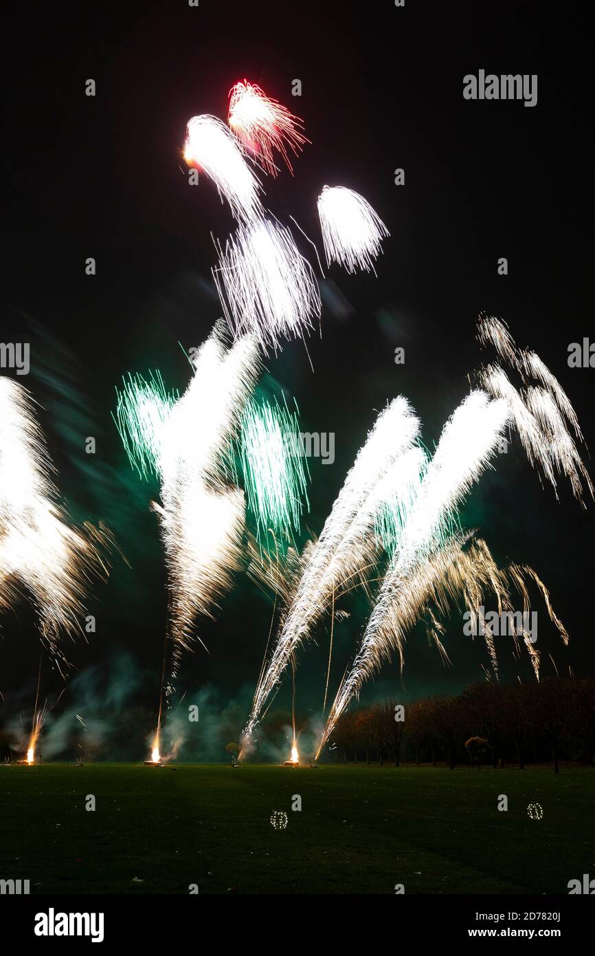 Spectacular and colourful firework display set against a dark Autumn ...