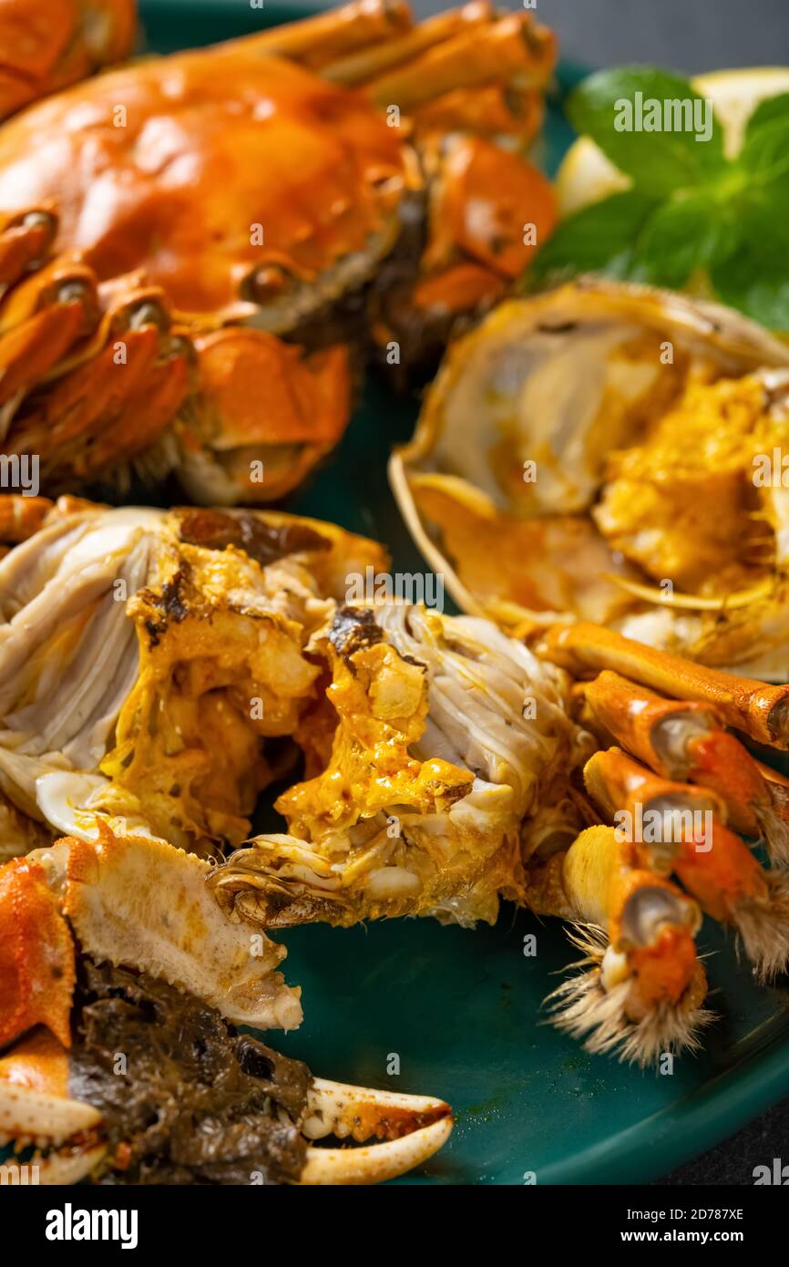 angle view crabs with one opened showing the crab roe and meat vertical ...