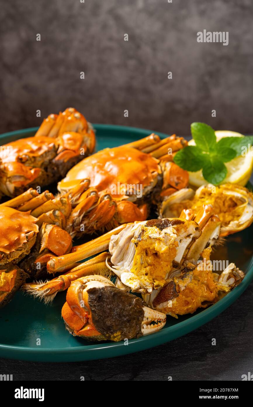 angle view crabs with one opened showing the crab roe and meat vertical ...