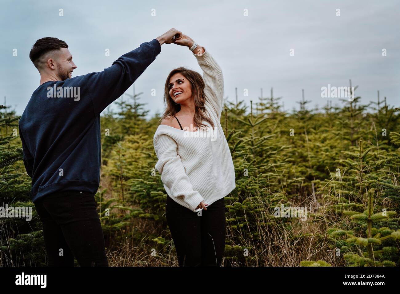 Young couple in Christmas Tree Field, UK Stock Photo - Alamy