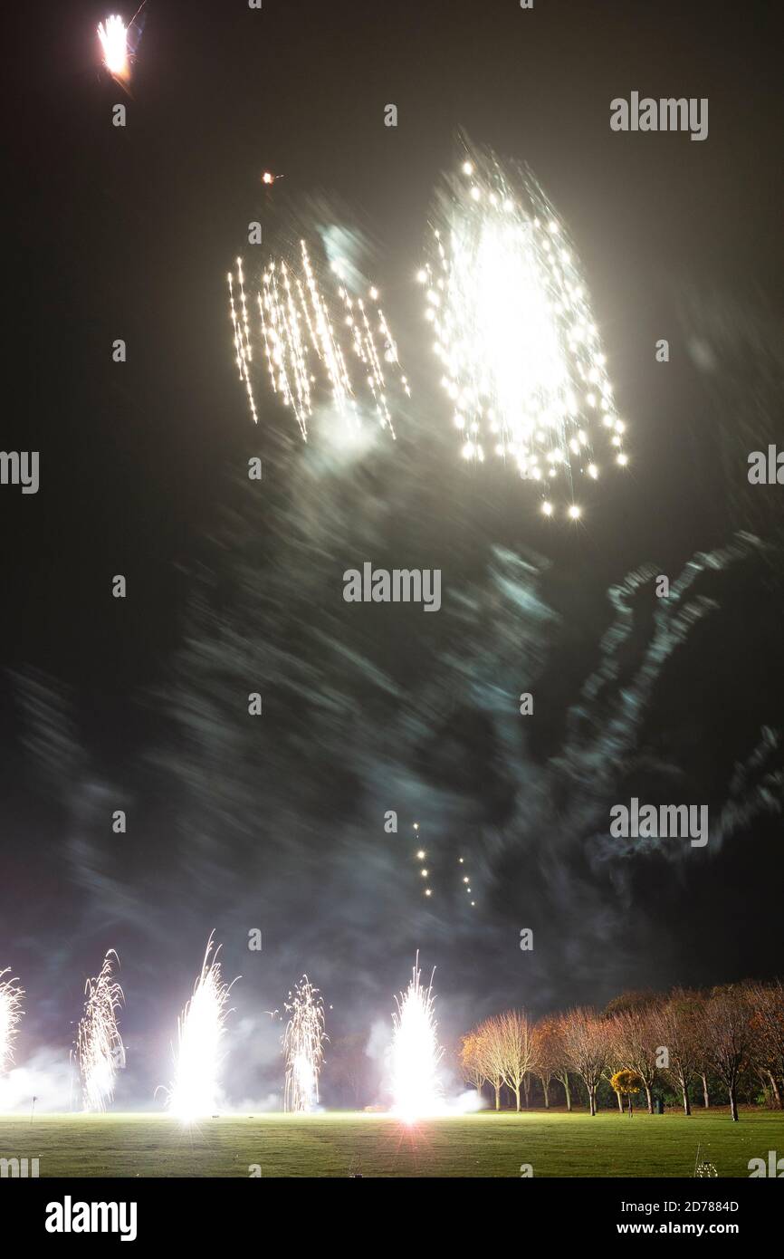 Spectacular and colourful firework display set against a dark Autumn ...