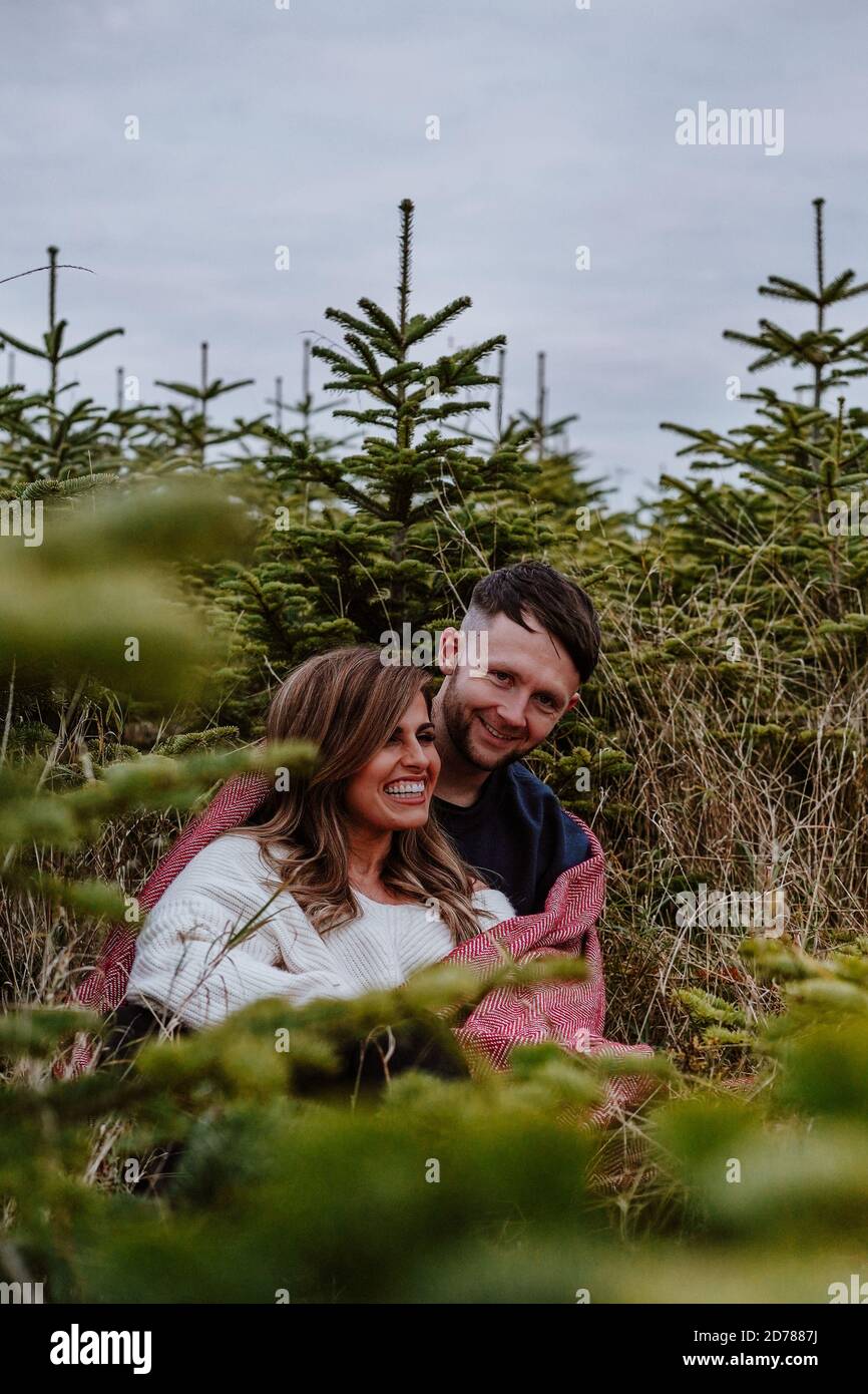 Young couple in Christmas Tree Field, UK Stock Photo - Alamy