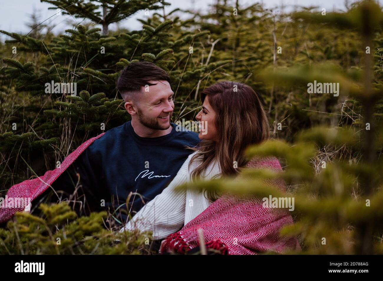 Young couple in Christmas Tree Field, UK Stock Photo - Alamy
