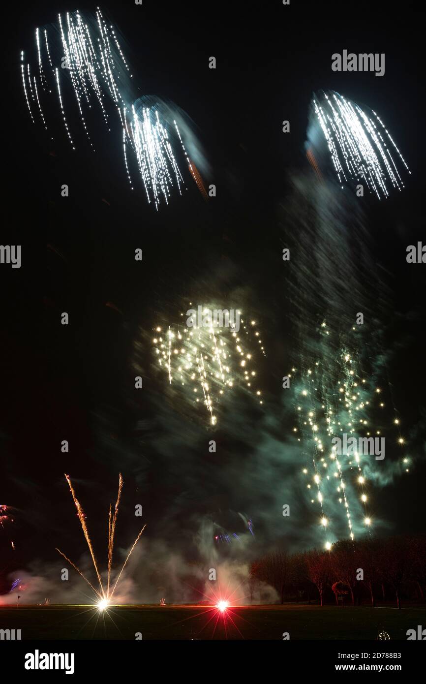 Spectacular and colourful firework display set against a dark Autumn ...