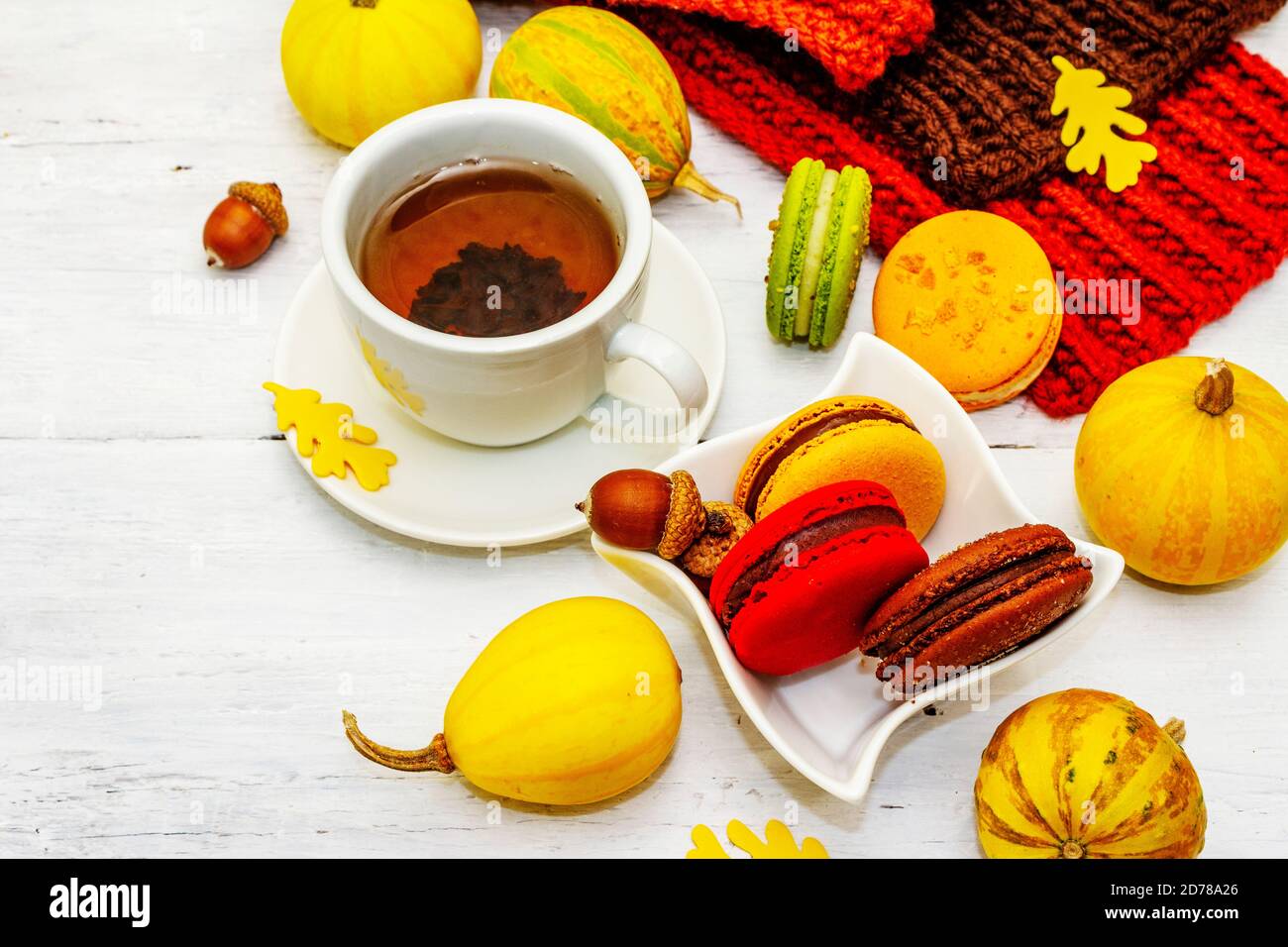 French macarons in autumn colors with hot tea. Halloween dessert ...
