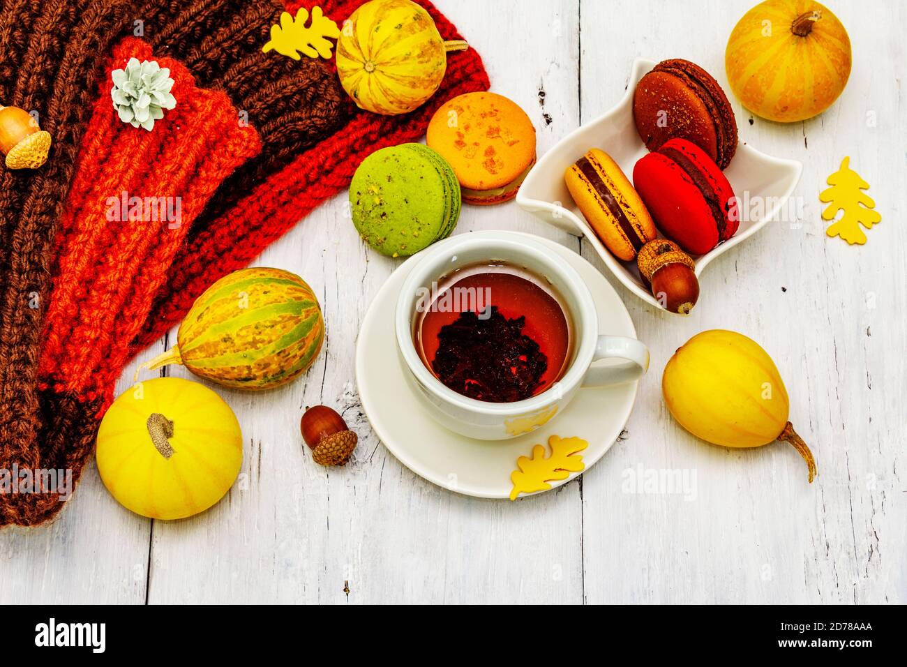 French macarons in autumn colors with hot tea. Halloween dessert ...