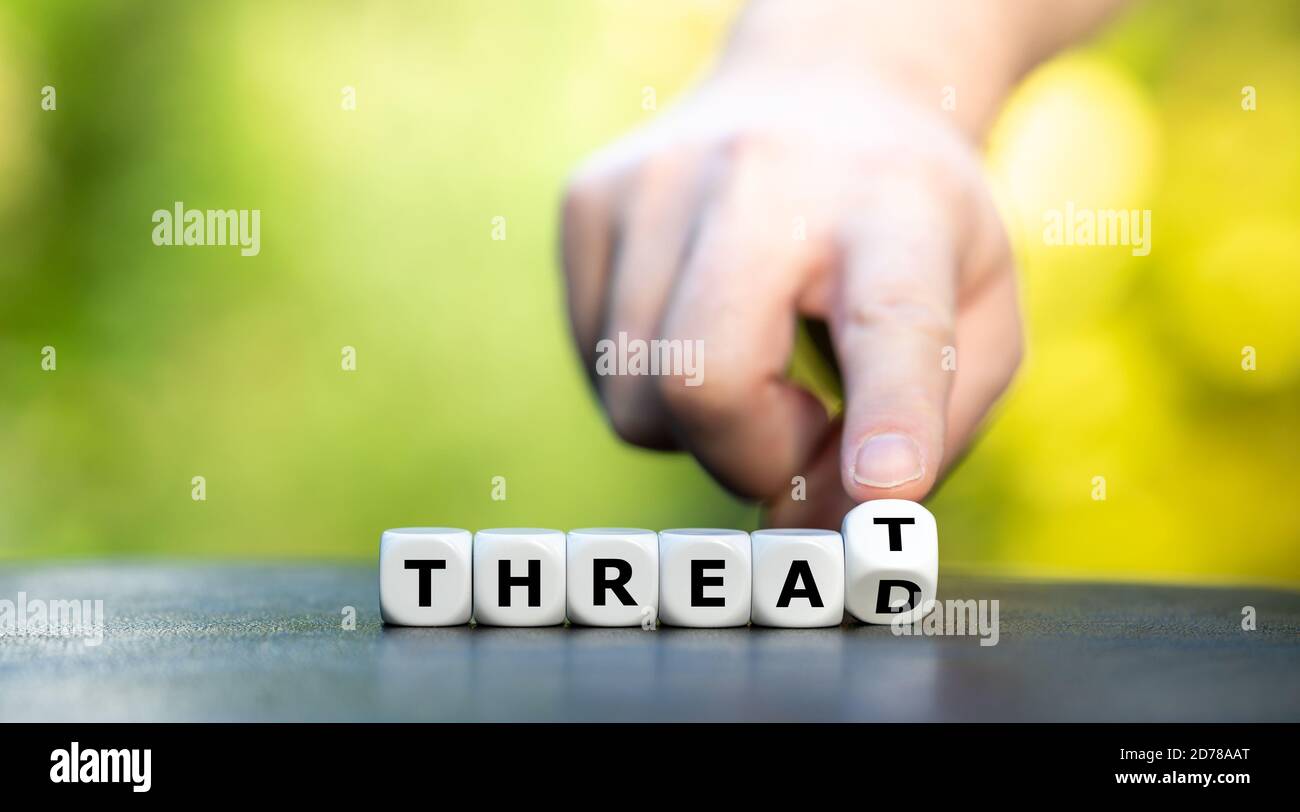 Symbol for online hate. Hand turns dice and changes the word "thread ...