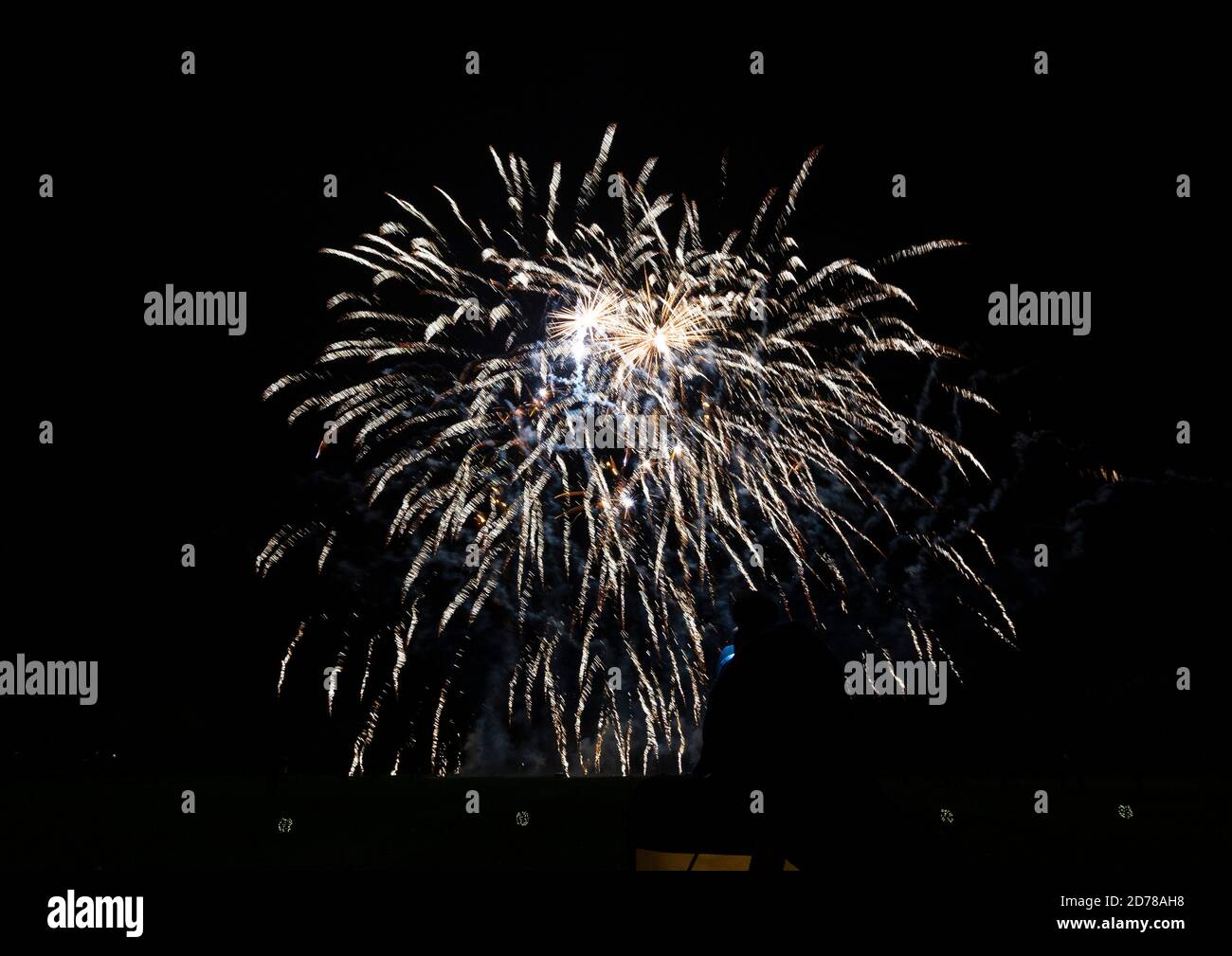 Spectacular and colourful firework display set against a dark Autumn ...