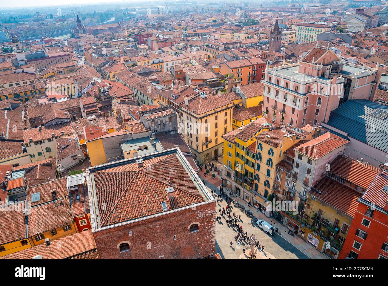 Aerial shot of an old town with orange rooftops, main street, and city ...
