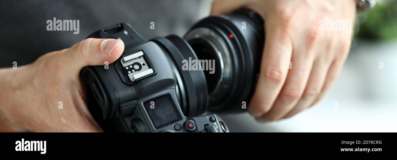 Male hands putting on modern digital camera professional lens Stock ...