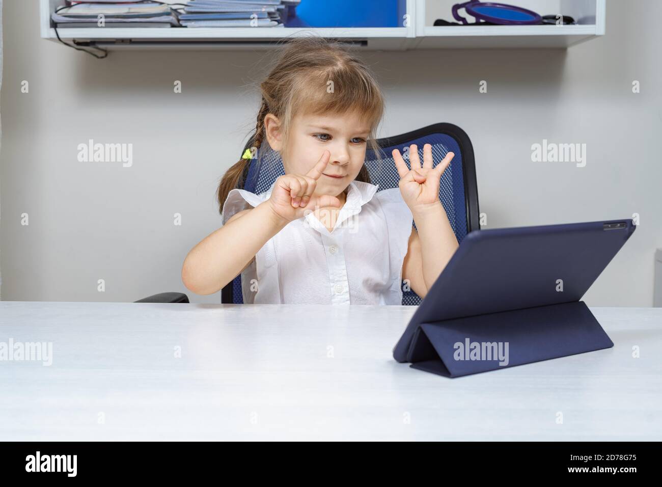 method of teaching quick mental math with fingers. little girl doing ...