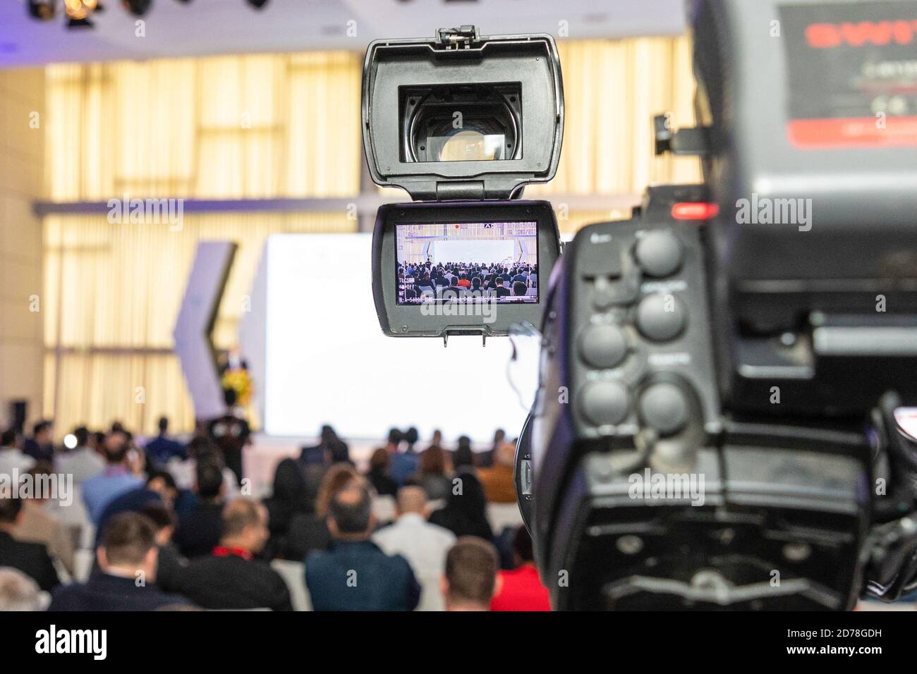 Professional digital camera recording video in business conference room ...